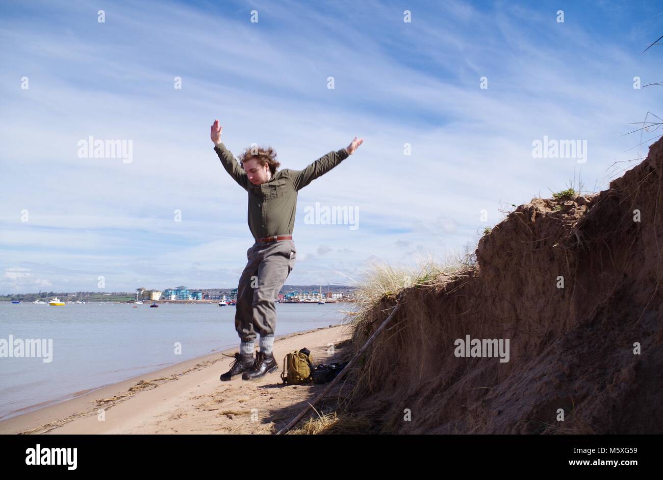 Ruggedly Handsome British Explorer, Dressed in Green Leaping from Sand ...