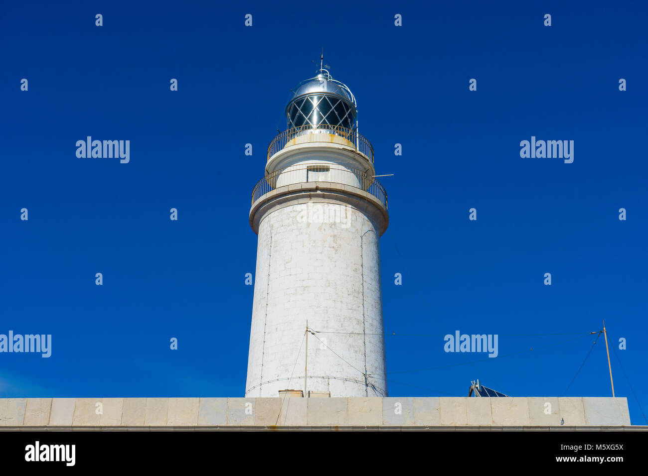 lighthouse next to the Mediterranean Sea, blue sky without clouds with ...