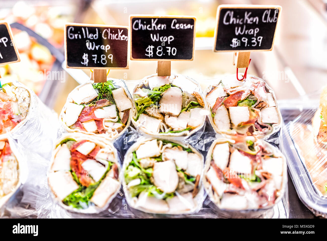 Signs, prices on display chicken club, grilled, and ceasar sandwiches ...