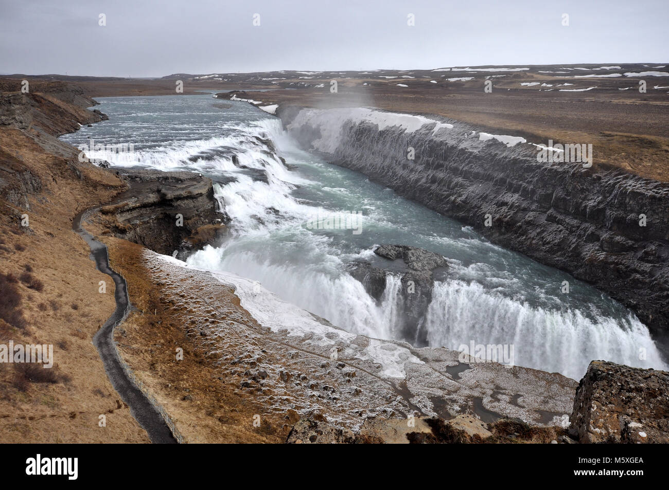High point view of the massive, fast flowing Gullfoss waterfall ...