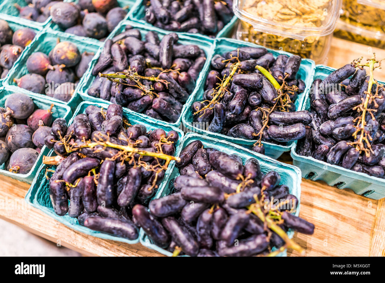 Closeup of many fresh purple juicy moon drop moondrop grapes in boxes ...