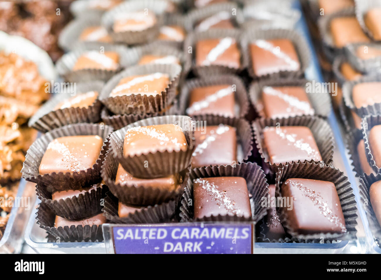 Macro closeup of chocolate dark salted caramels squares bars candy ...