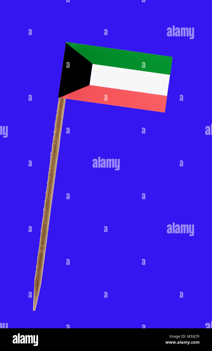 Tooth pick wit a small paper flag of Kuwait on a blue screen for ...