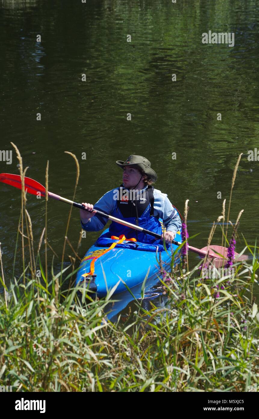 Young Handsome Man, River Kayaking in a Blue Kayak on the River Exe ...