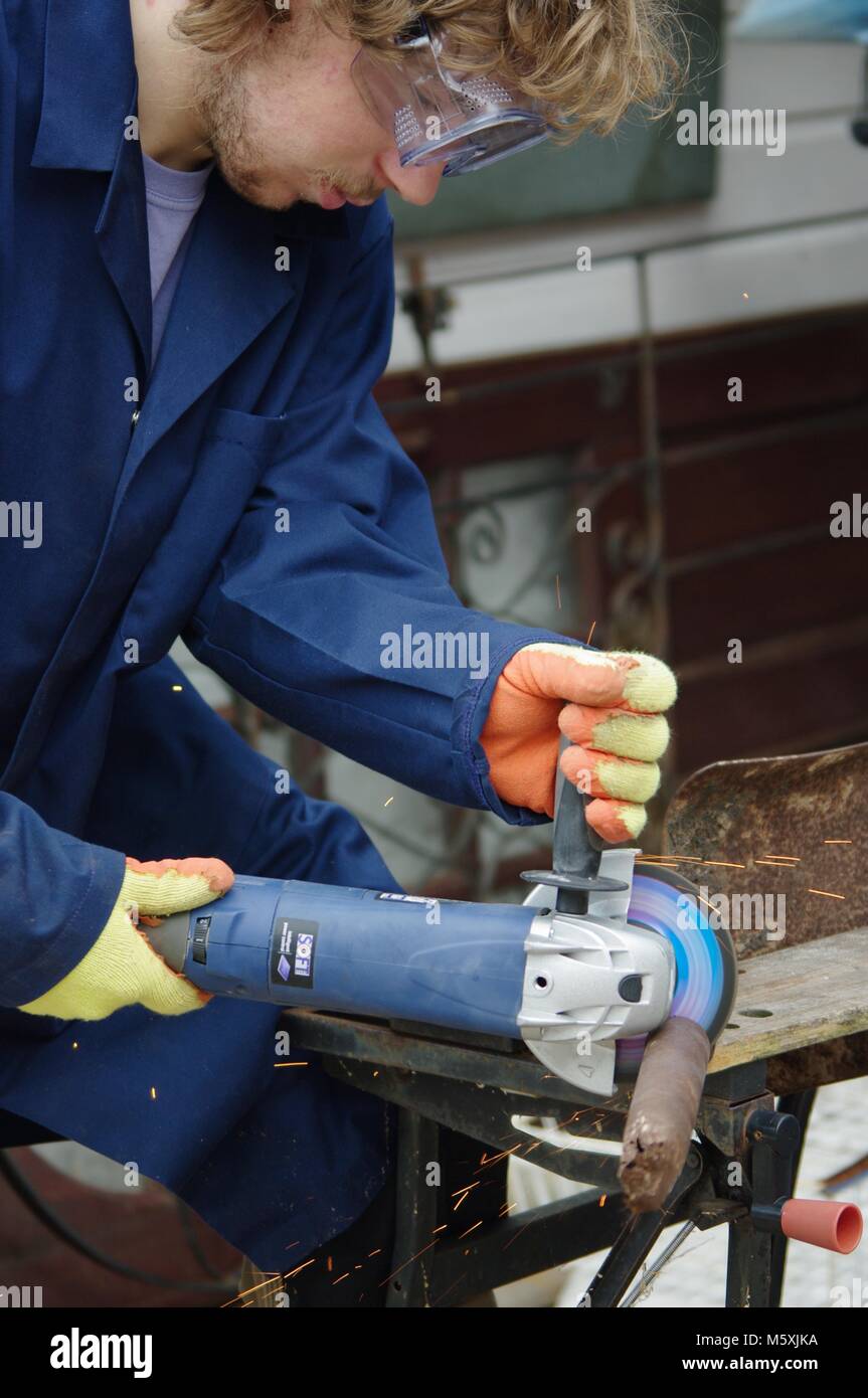 Young Man with a Power Tool Undertaking DIY Home Improvement Work in a ...