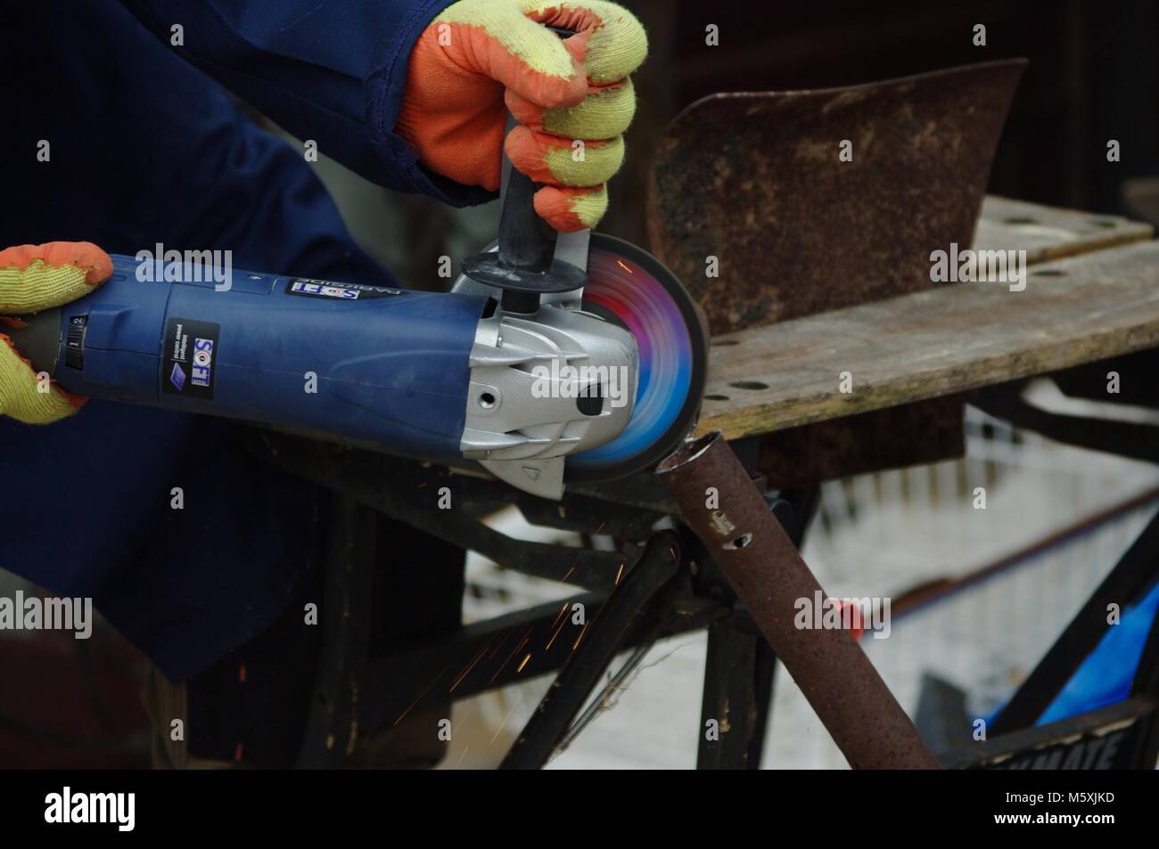 Young Man with a Power Tool Undertaking DIY Home Improvement Work in a ...
