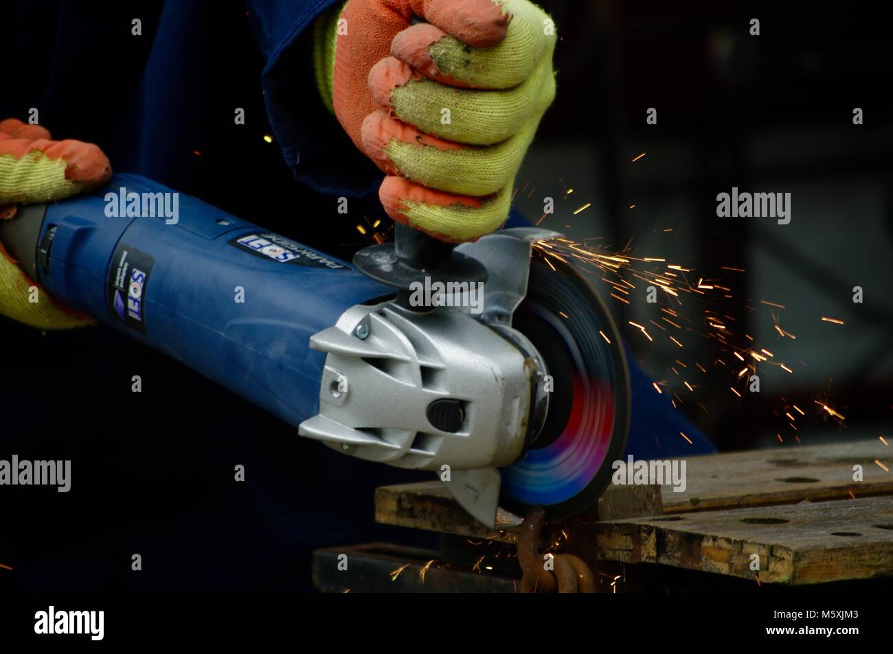 Young Man with a Power Tool Undertaking DIY Home Improvement Work in a ...