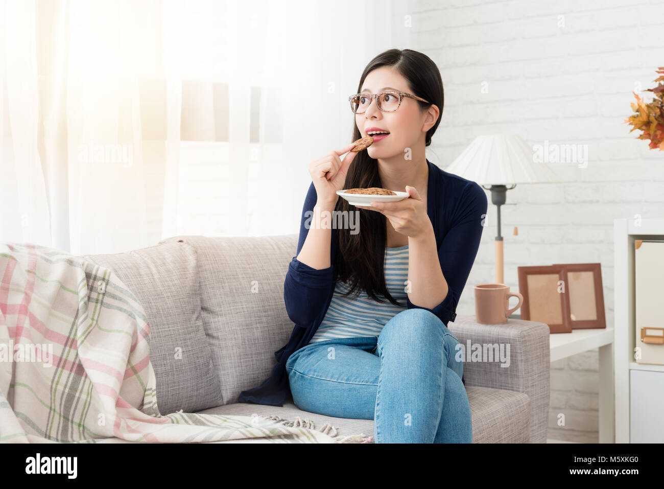 beautiful Asian women enjoy eating the biscuit and looking view of the ...