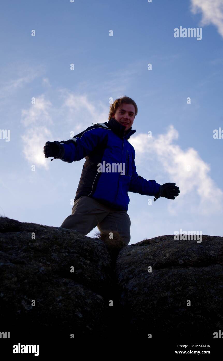 Young Male Hill Walker ontop of the Granite Tor, of Haytor on a Windy ...