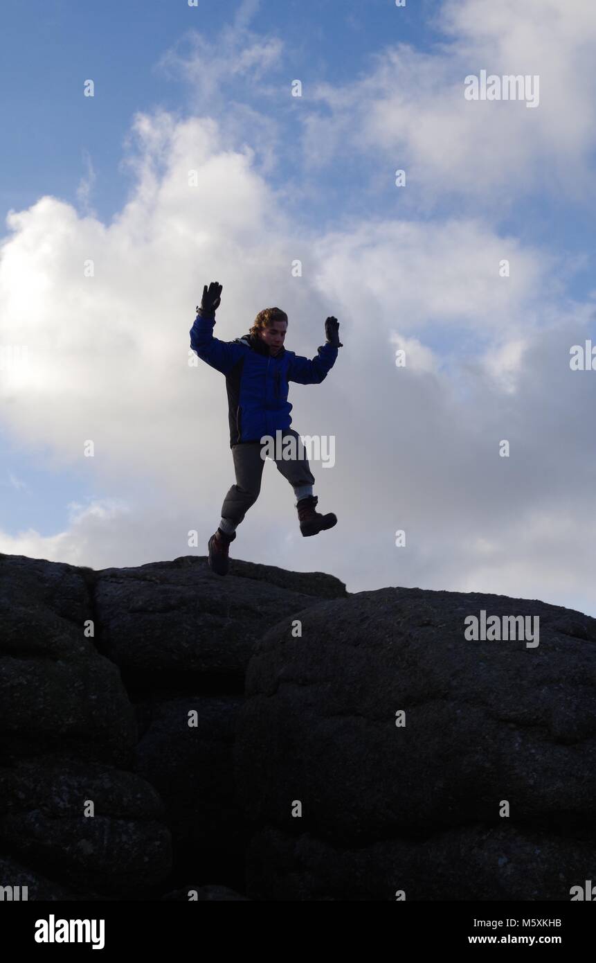 Young Male Hill Walker ontop of the Granite Tor, of Haytor on a Windy ...