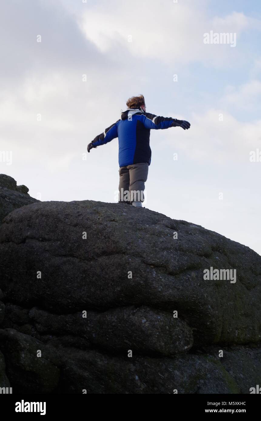 Young Male Hill Walker ontop of the Granite Tor, of Haytor on a Windy ...