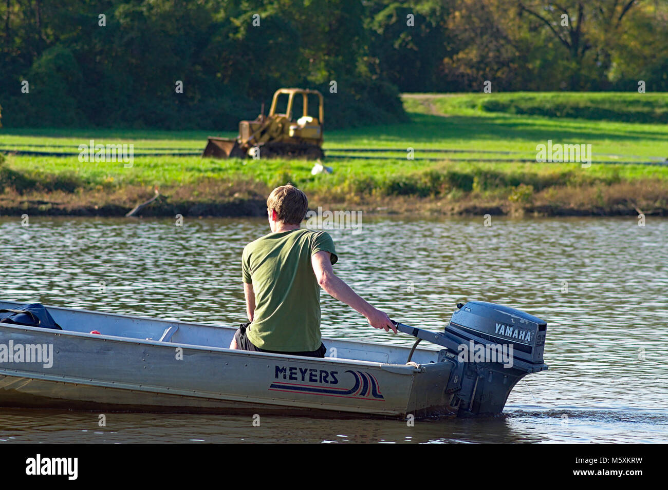 One person steering small engine boat Stock Photo - Alamy