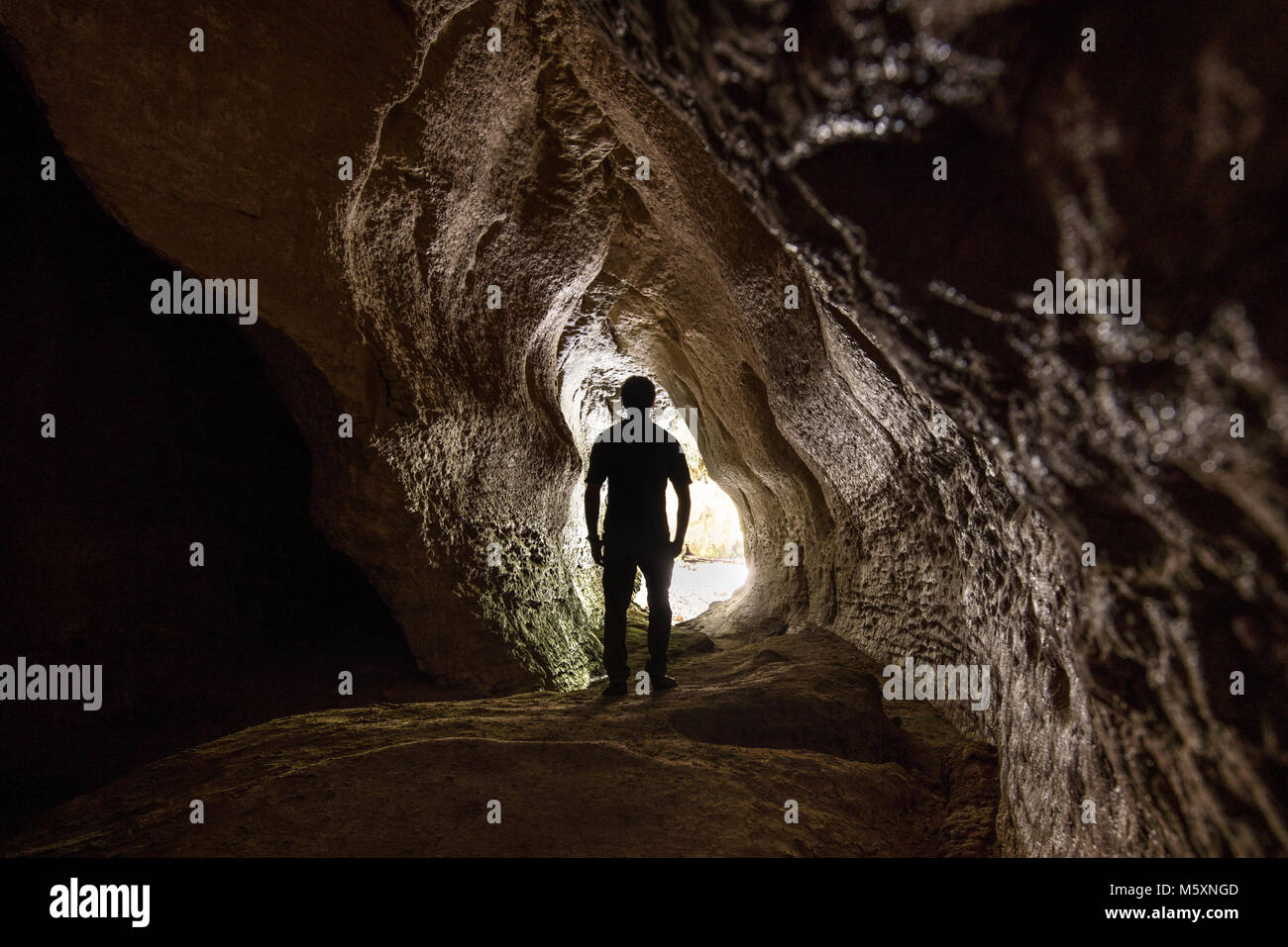 Silhoutte of Hiker in huge mysterious cave, Oparara Basin, Moria Gate ...