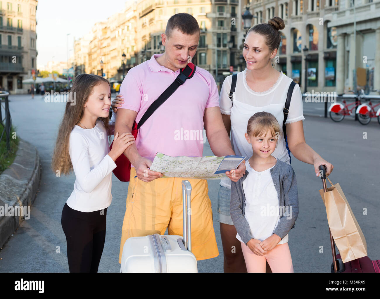 positive italian parents with two kids traveling together searching ...