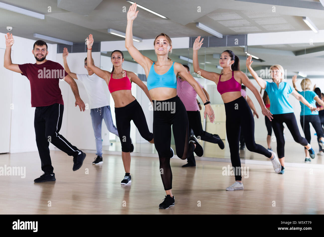 Group of energetic people dancing together in studio Stock Photo - Alamy