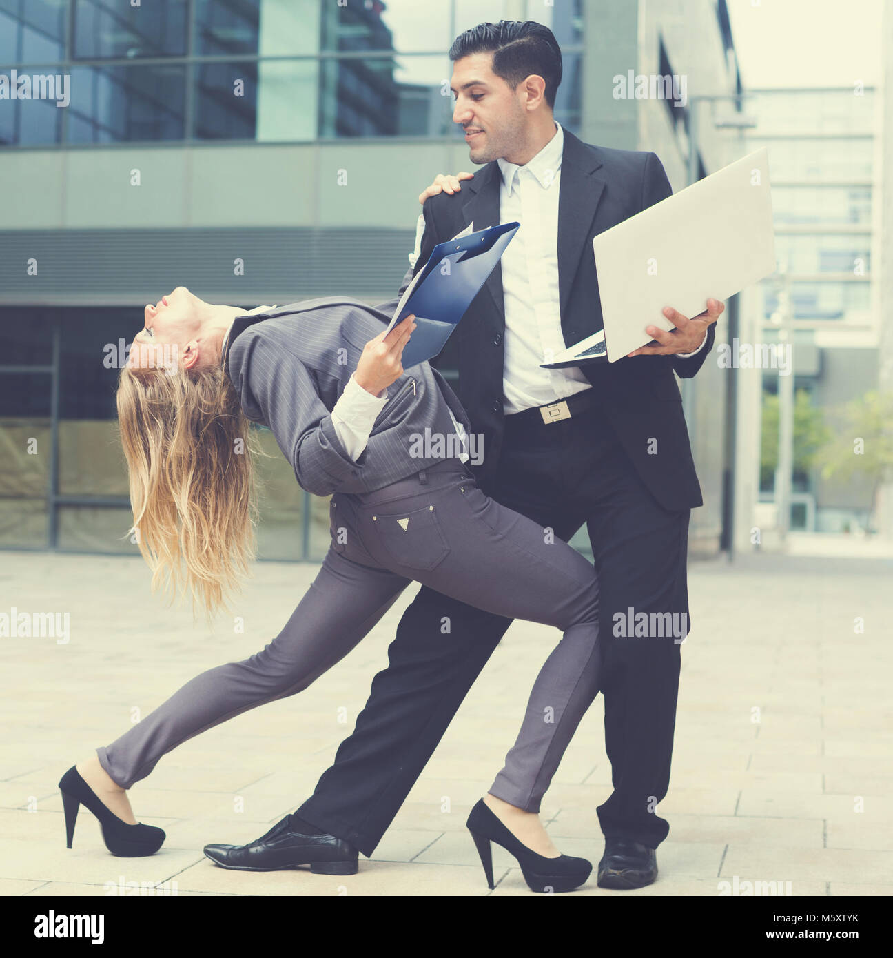 Couple of managers are dancing near office in time break Stock Photo ...