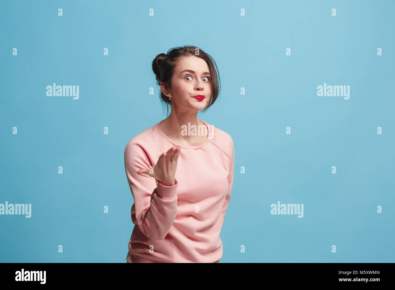 Beautiful female half-length portrait isolated on blue studio backgroud ...