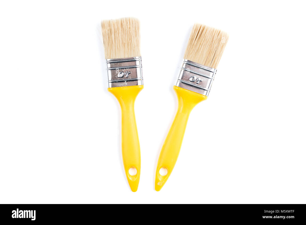 Two Yellow paintbrushes isolated on a white background. Industrial ...