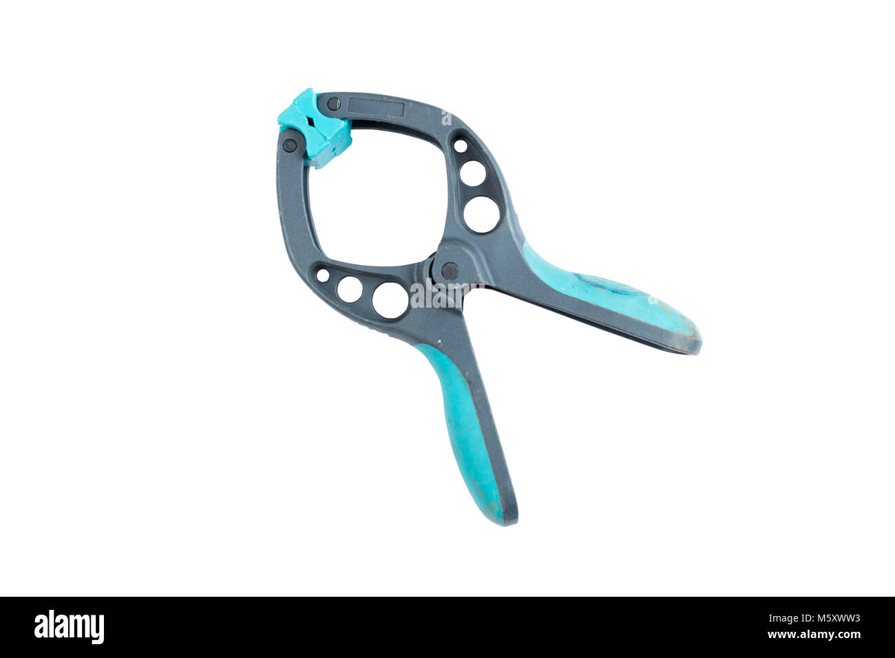 Plastic clamp isolated on a white background. Green plastic spring ...