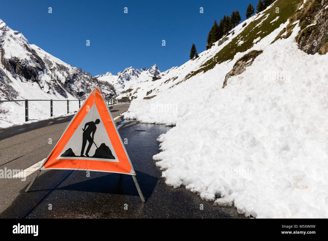 Warning sign because of a road blocked by a snow slide in the Alps ...