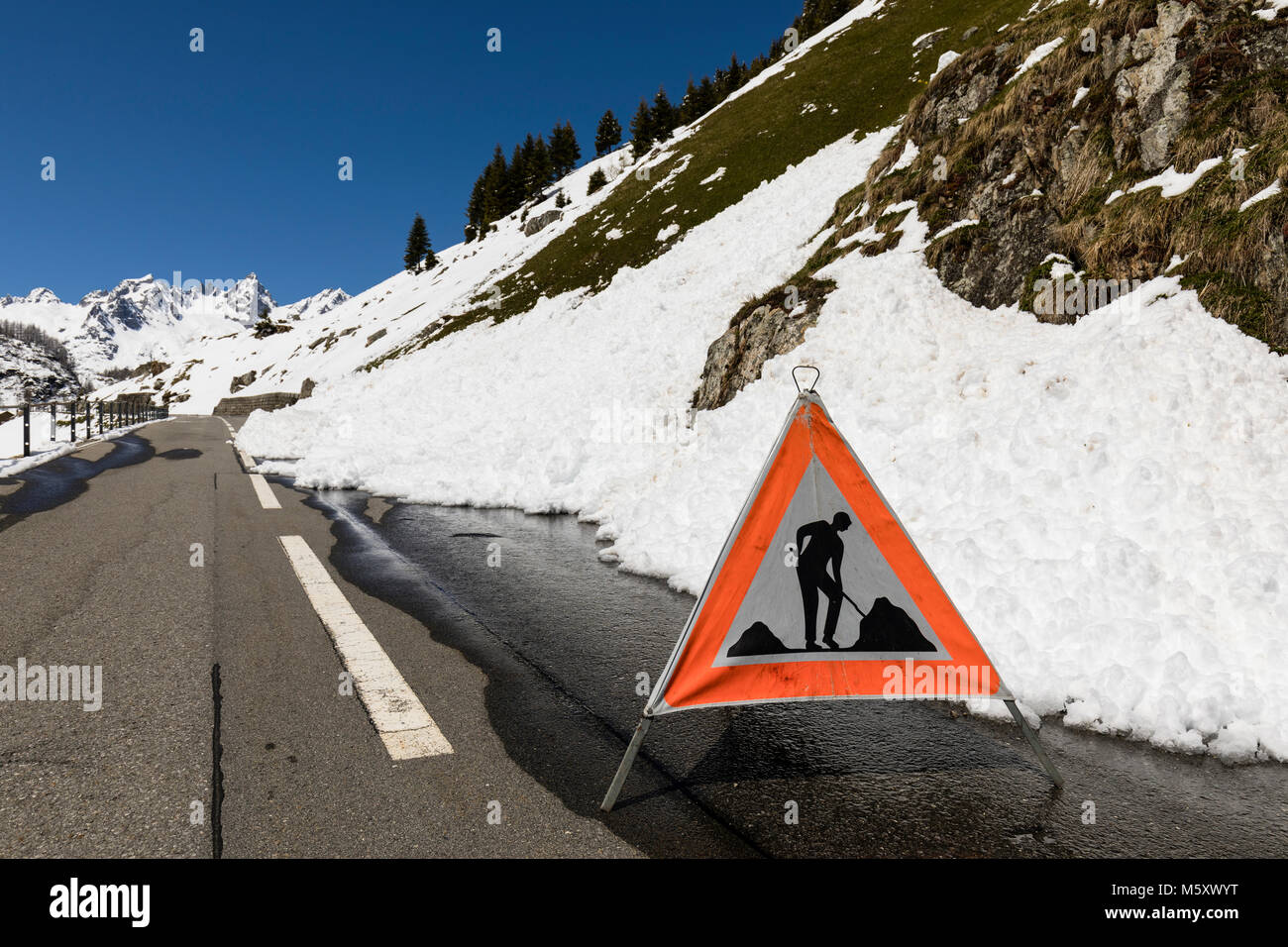 Warning sign because of a road blocked by a snow slide in the Alps ...