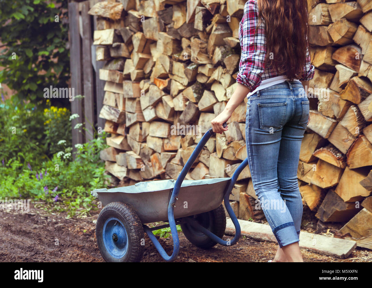 Beautiful youngcountry woman posing on firewood background Stock Photo ...