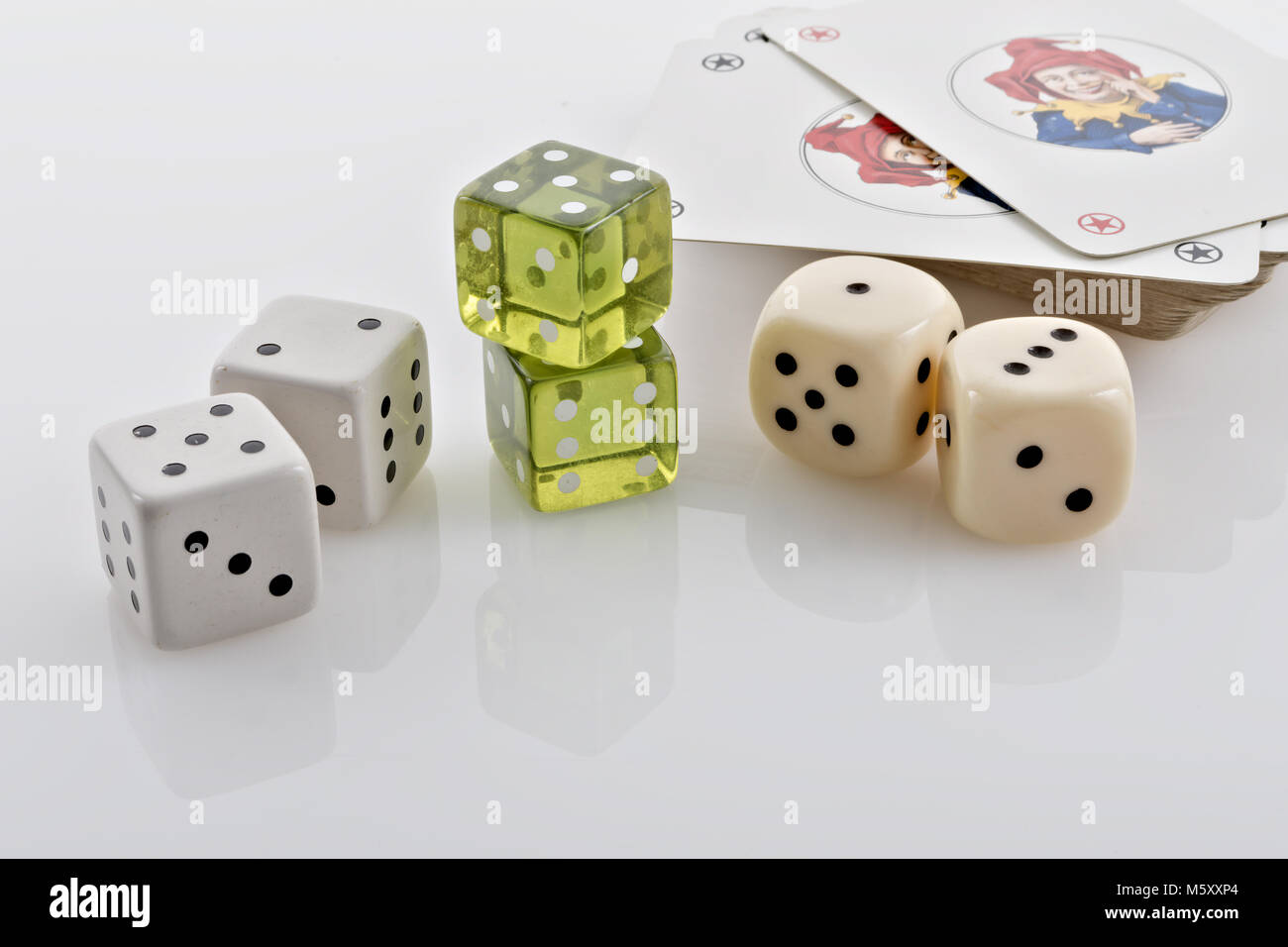 playing dice on a white background with cards Stock Photo - Alamy