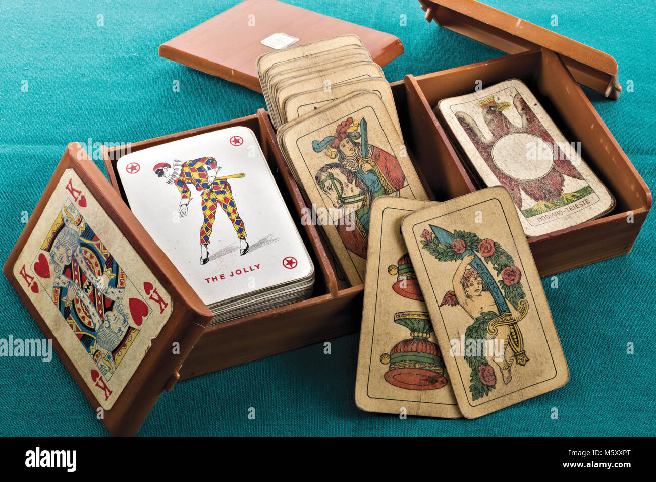 old playing cards with container Stock Photo - Alamy