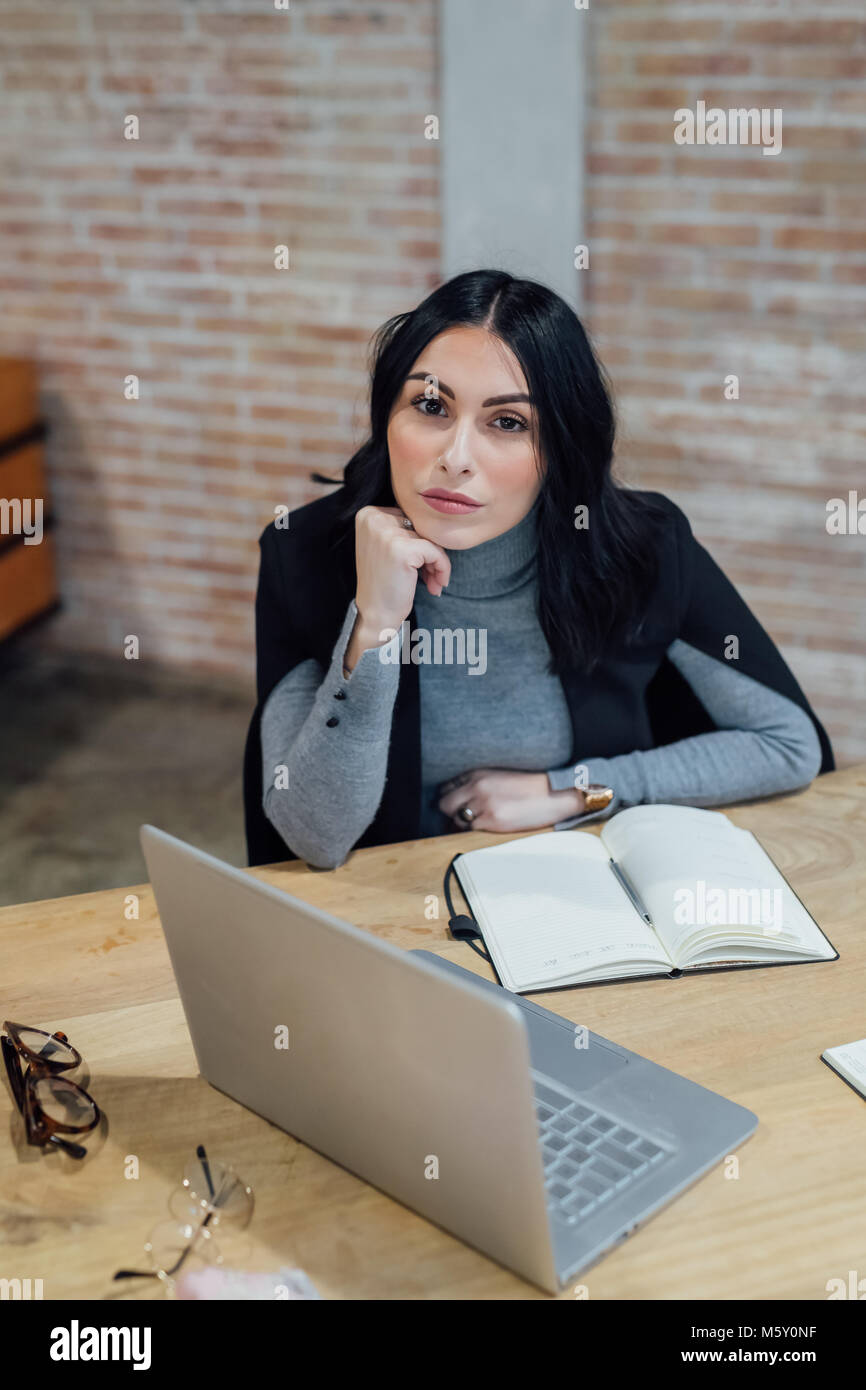 young beautiful woman indoor using computer sitting working desk ...