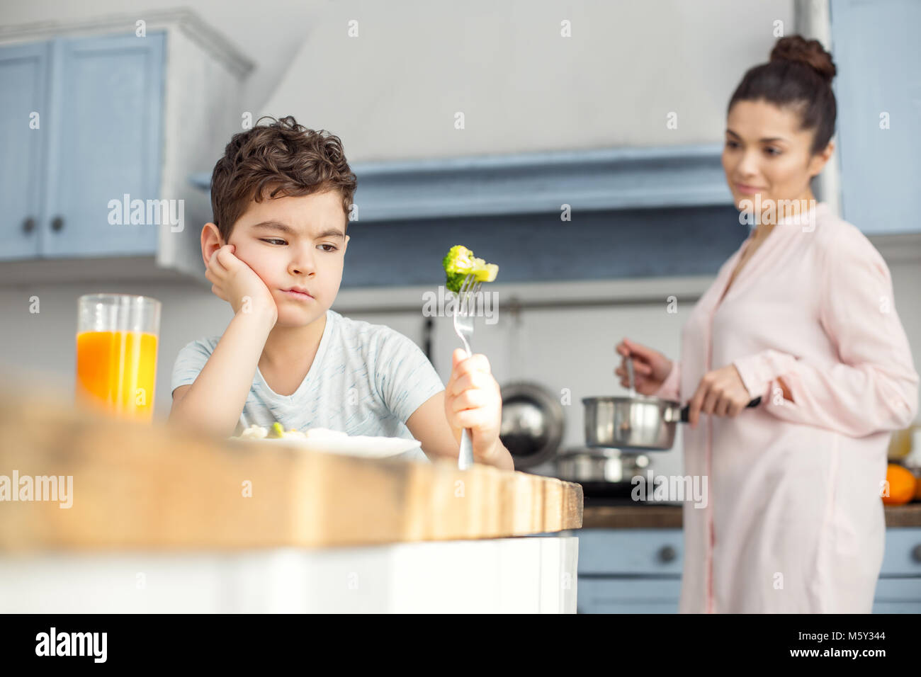 Unhappy kid dinner hi-res stock photography and images - Alamy