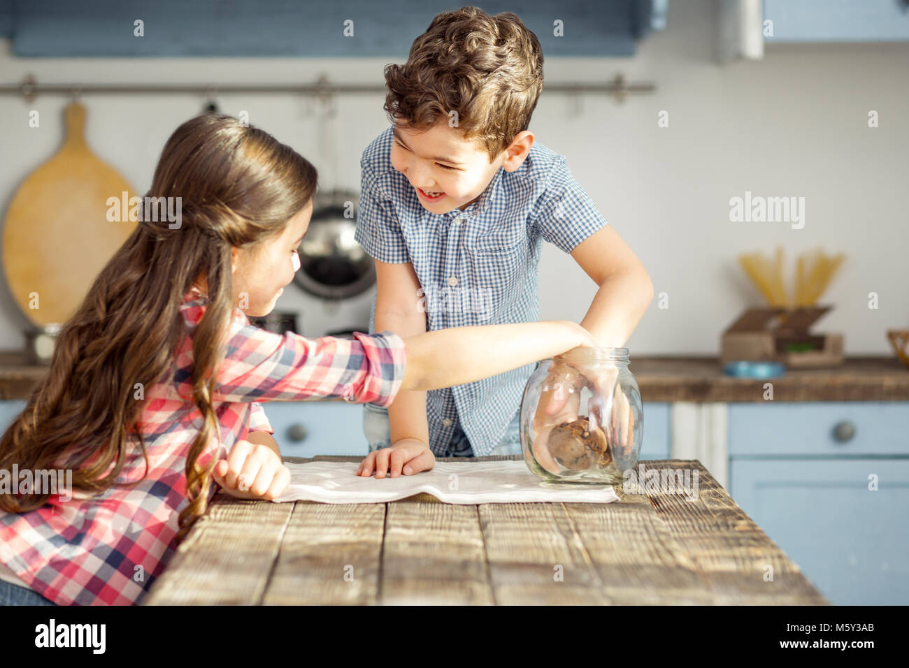Content children having some cookies Stock Photo - Alamy