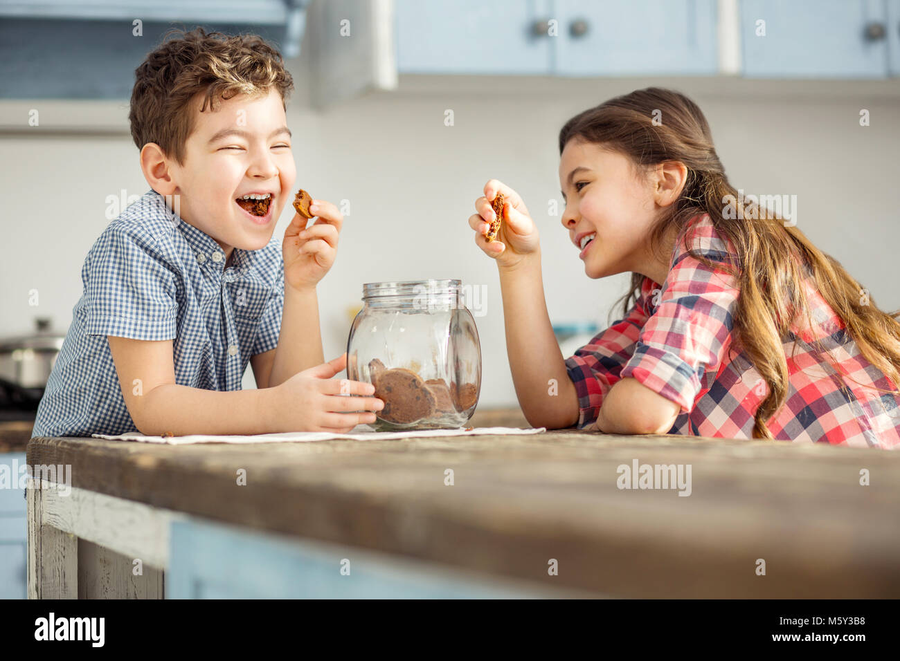 Inspired children having some cookies Stock Photo - Alamy