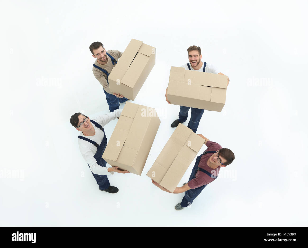 Movers lifting stack of cardboard moving boxes isolated on white Stock ...