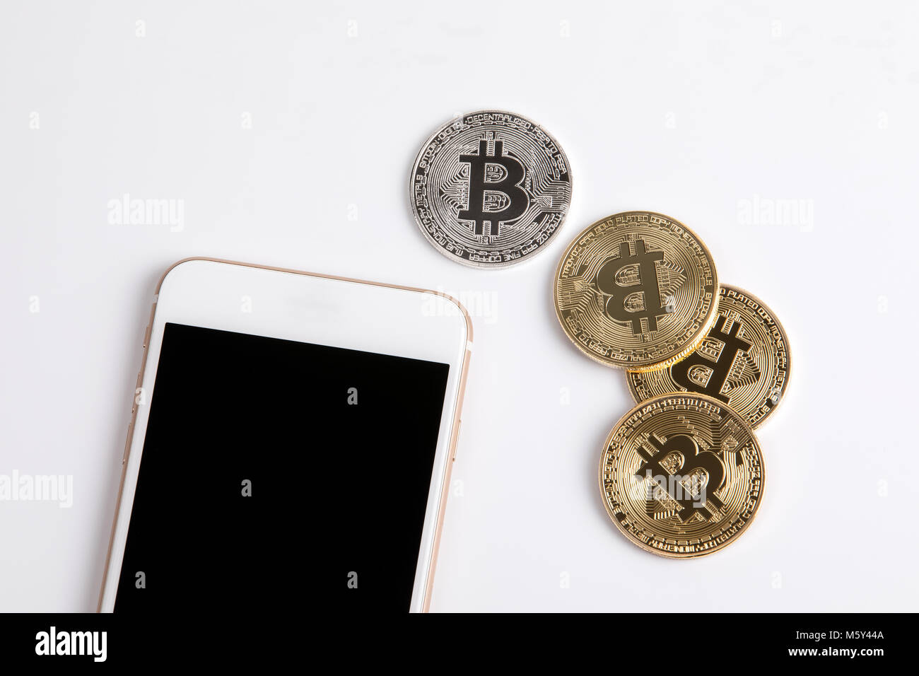 crypto currency, golden bitcoin and mobile phone on white background ...