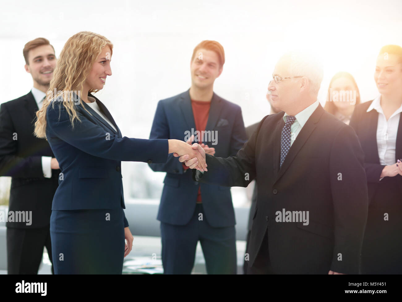 handshake serious businessman and business woman Stock Photo - Alamy