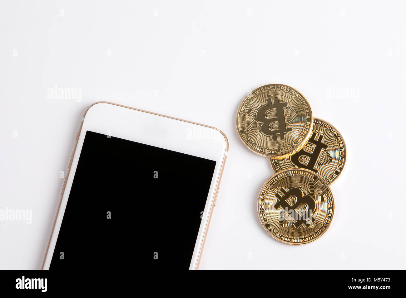 crypto currency, golden bitcoin and mobile phone on white background ...