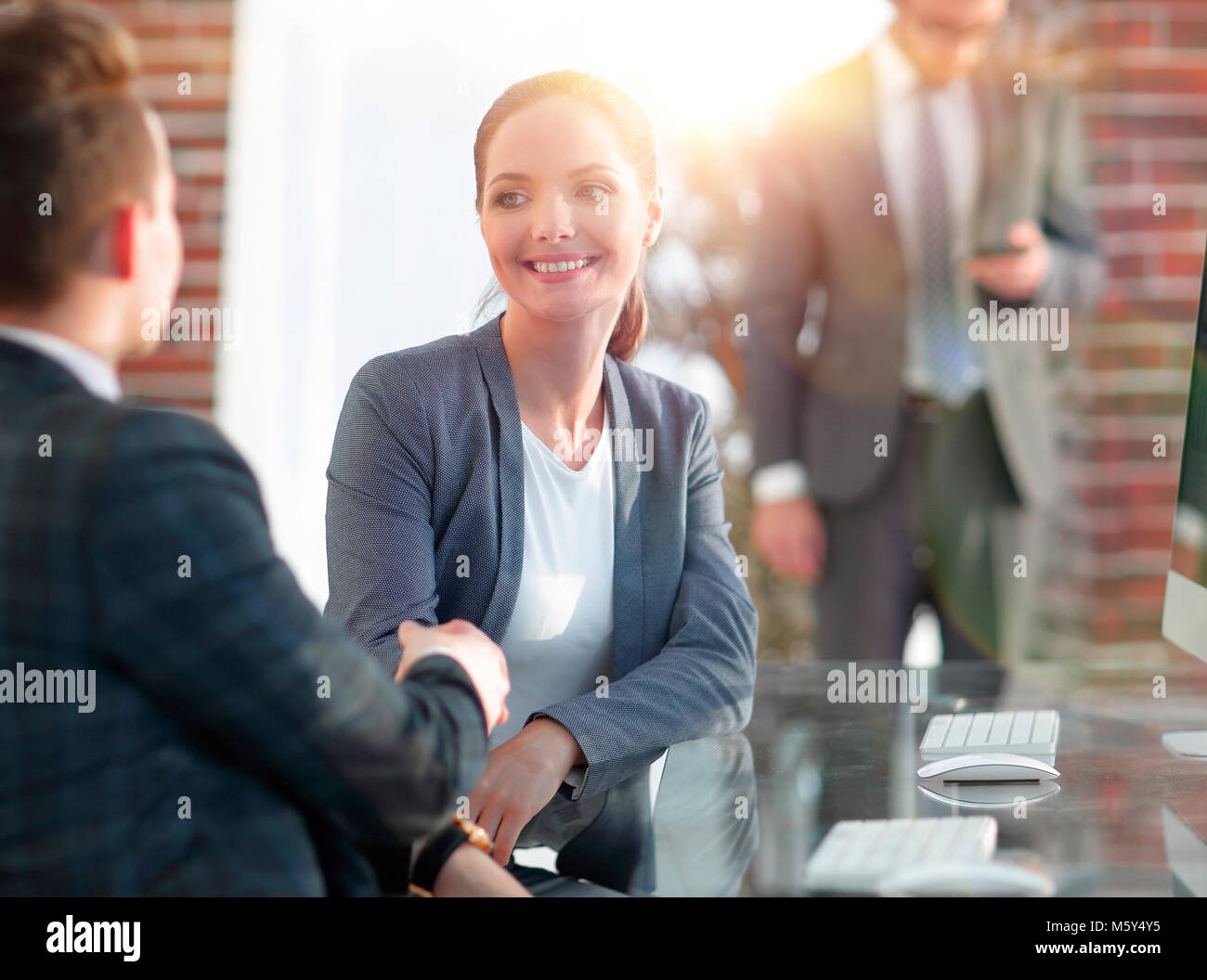 handshake Manager and the client in the office Stock Photo - Alamy