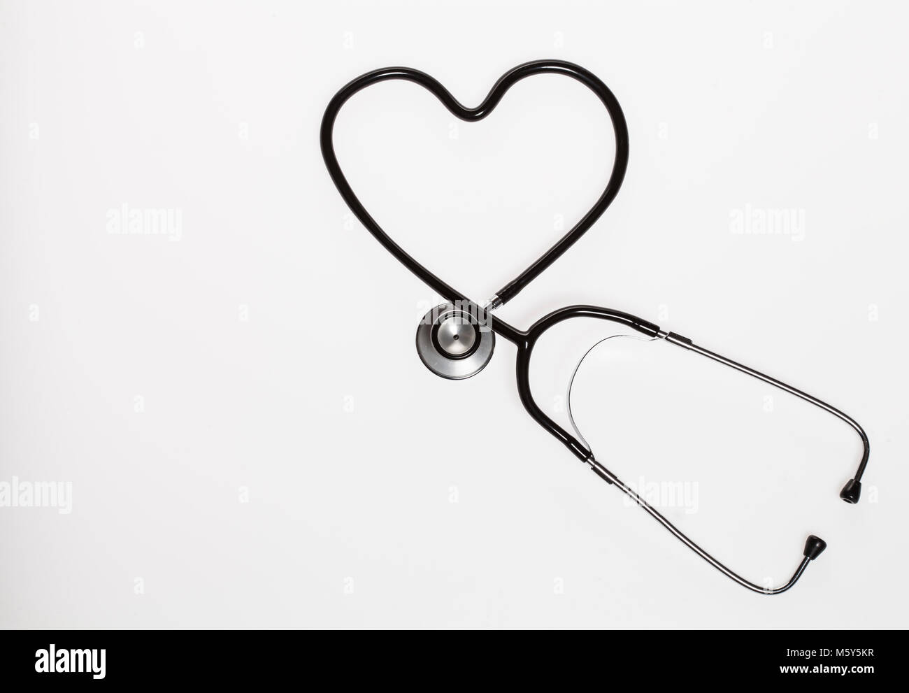 Stethoscope in the shape of heart on white background Stock Photo - Alamy
