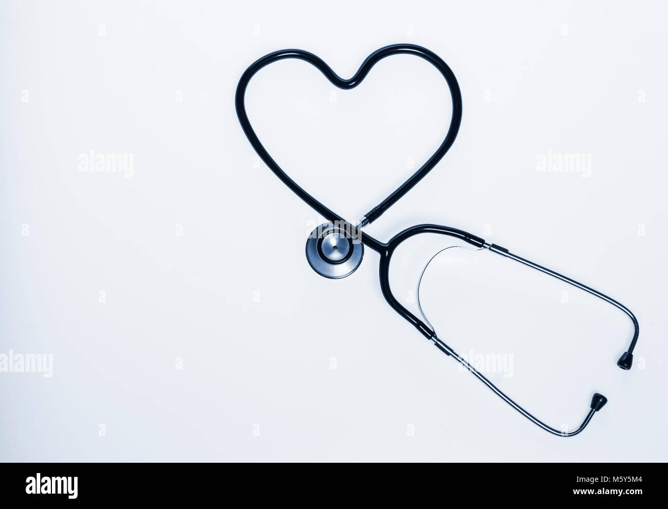 Stethoscope in the shape of heart on white background Stock Photo - Alamy