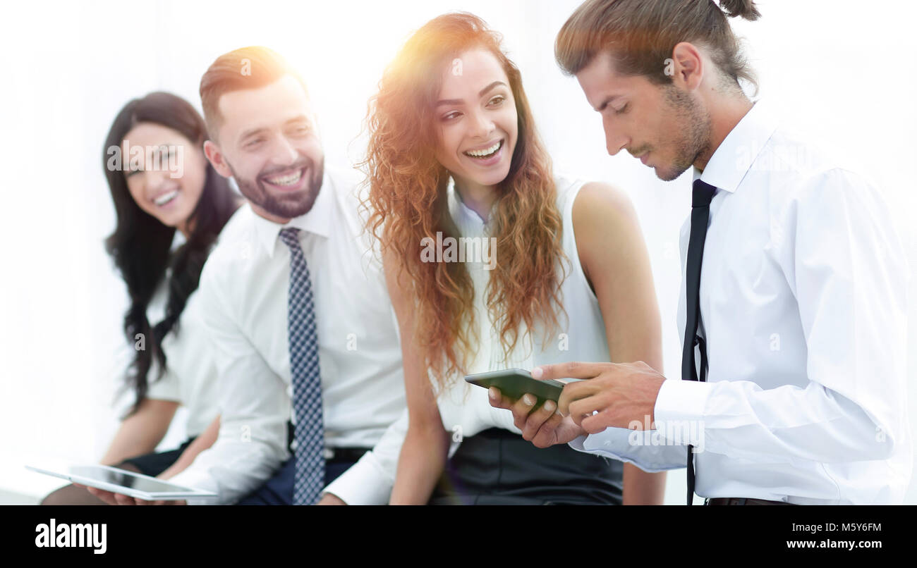 business team with tablet sitting in the office Stock Photo - Alamy
