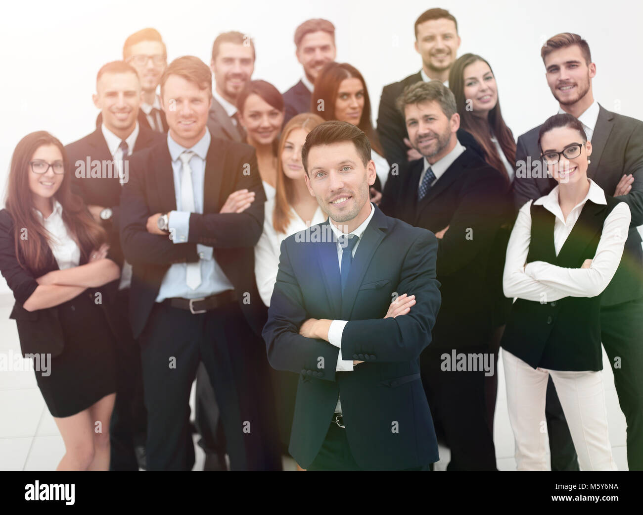 leader standing in front of a large business team Stock Photo - Alamy