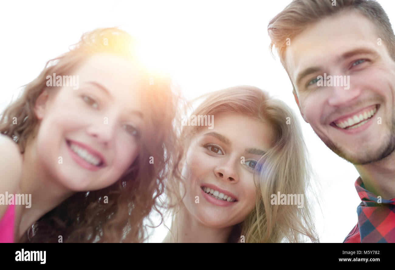 closeup of three young people smiling on white background Stock Photo ...