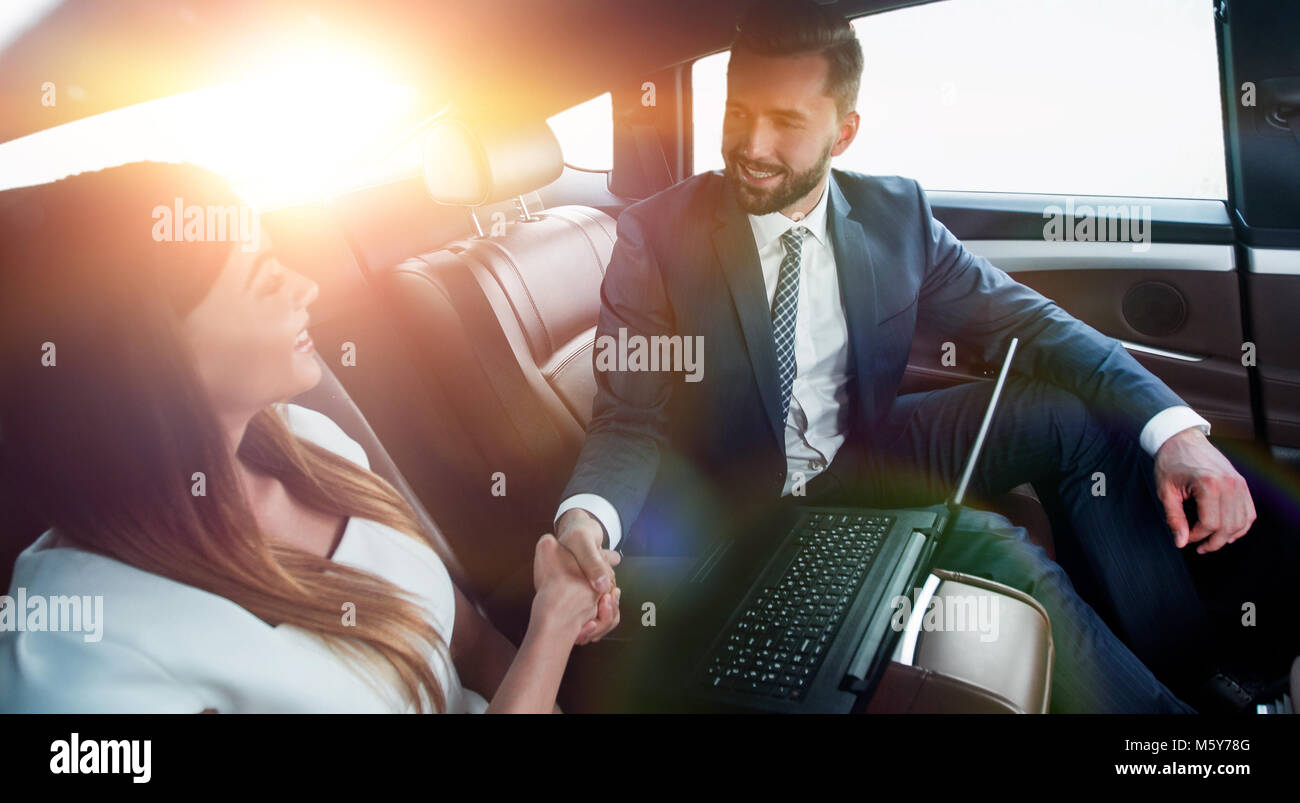 man and woman shaking hands in car Stock Photo - Alamy