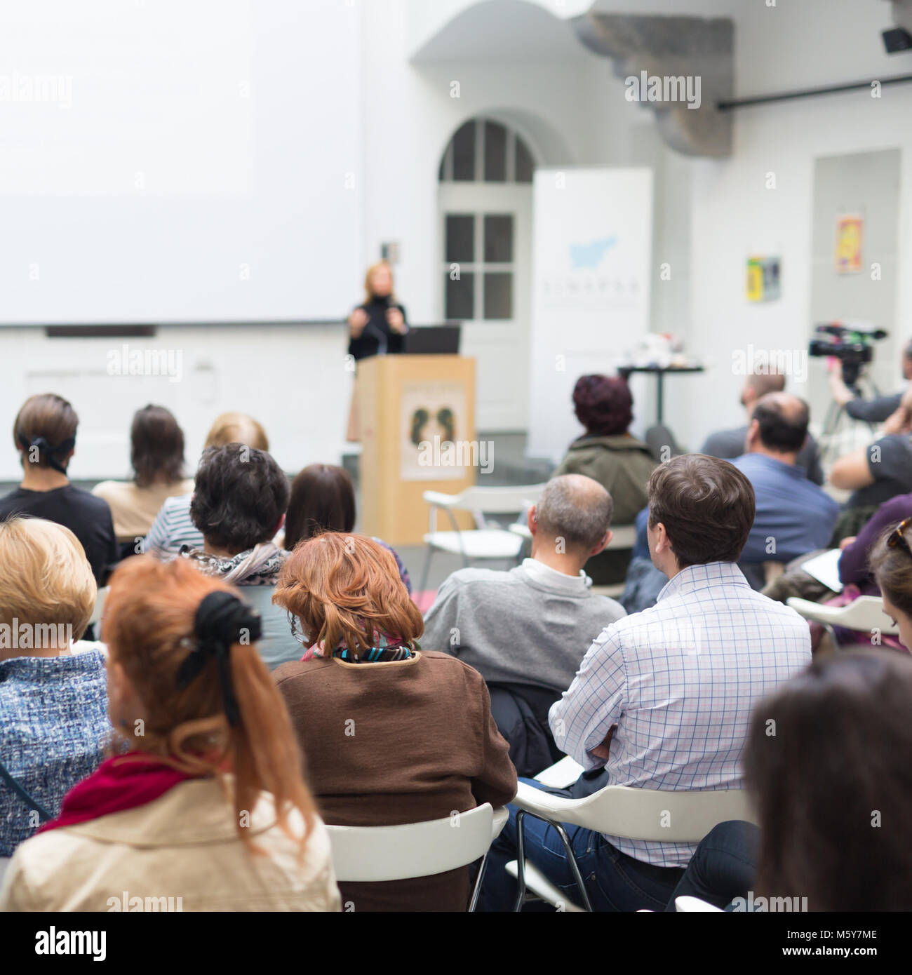 Woman giving presentation in lecture hall at university Stock Photo - Alamy