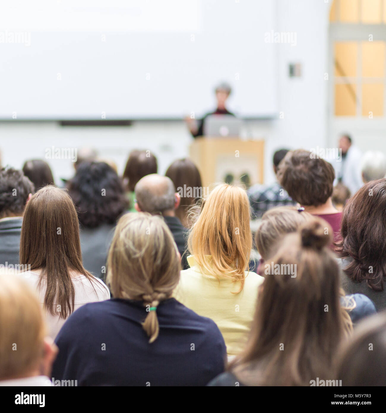 Woman giving presentation in lecture hall at university Stock Photo - Alamy