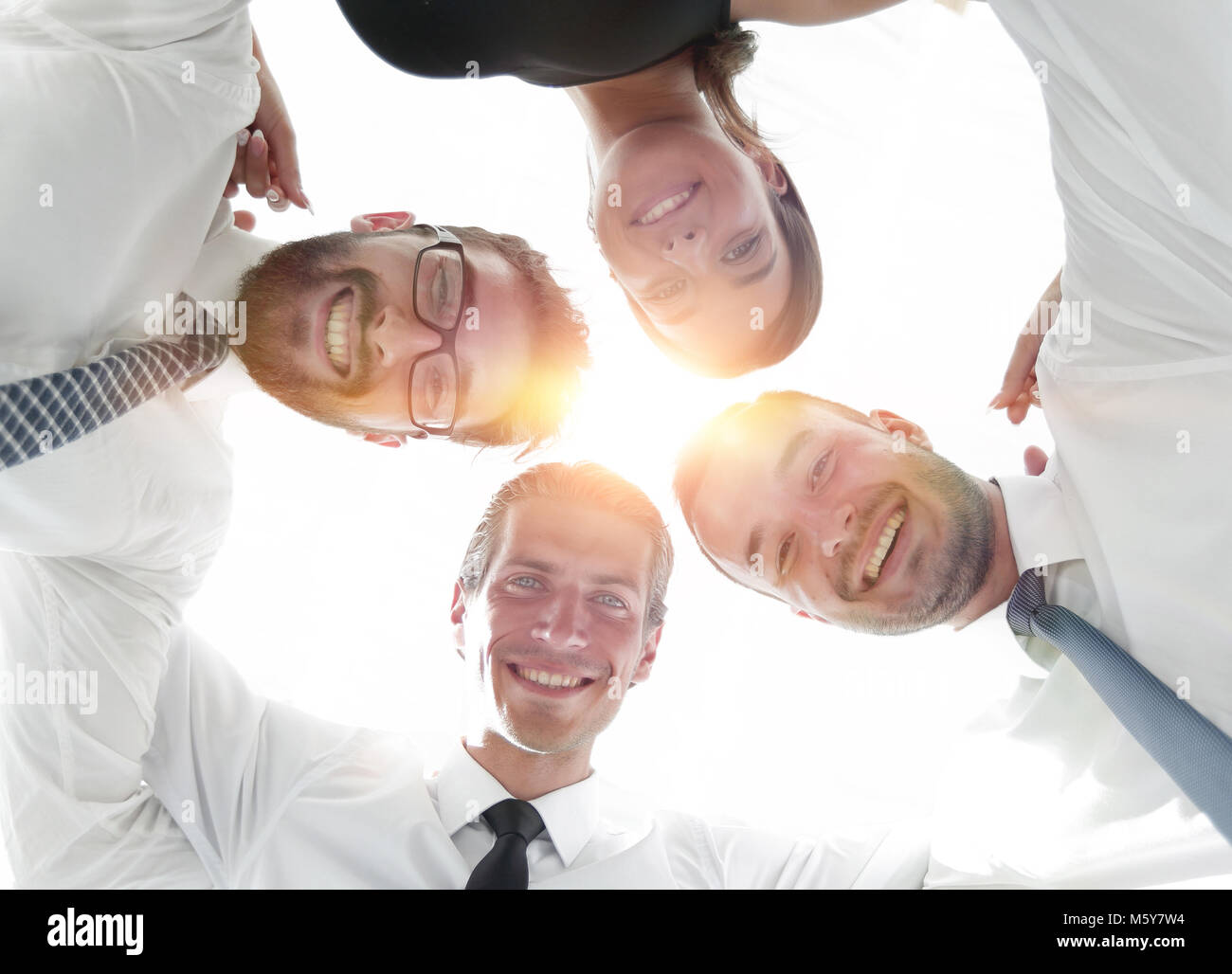 closeup.bottom view.successful business team with arms around each ...