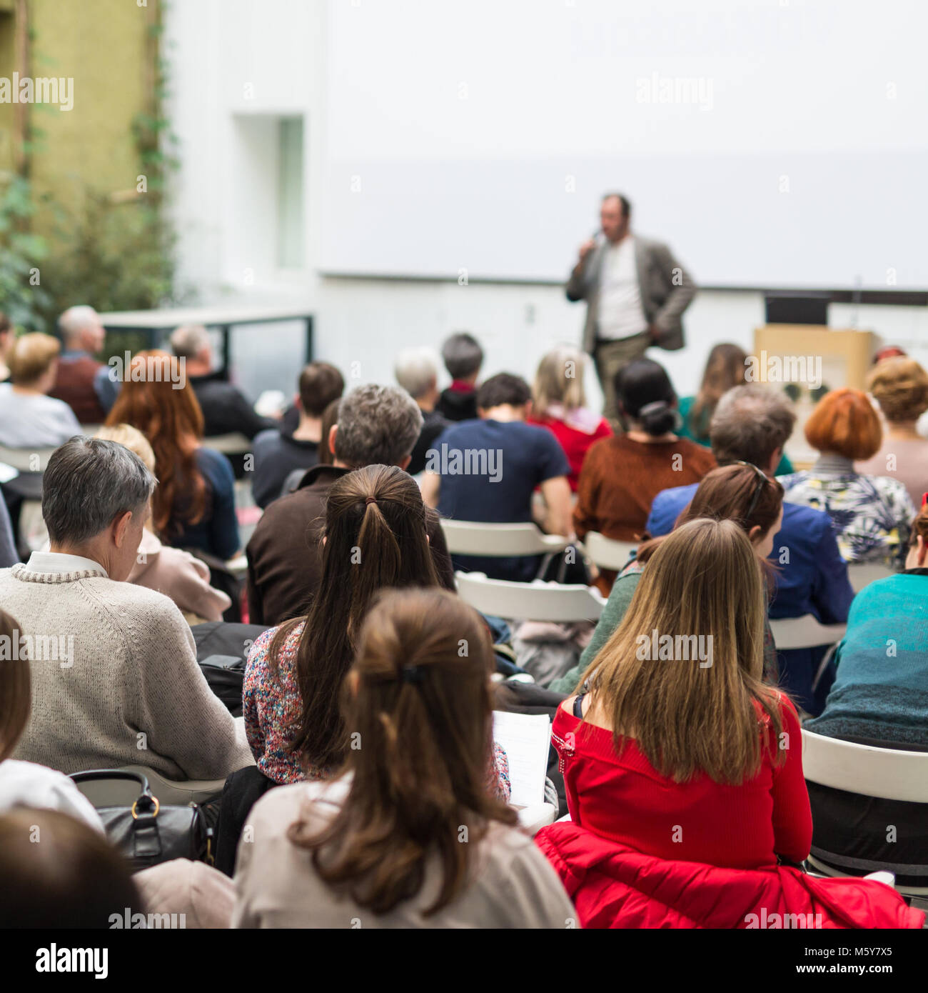 Man giving presentation in lecture hall at university Stock Photo - Alamy