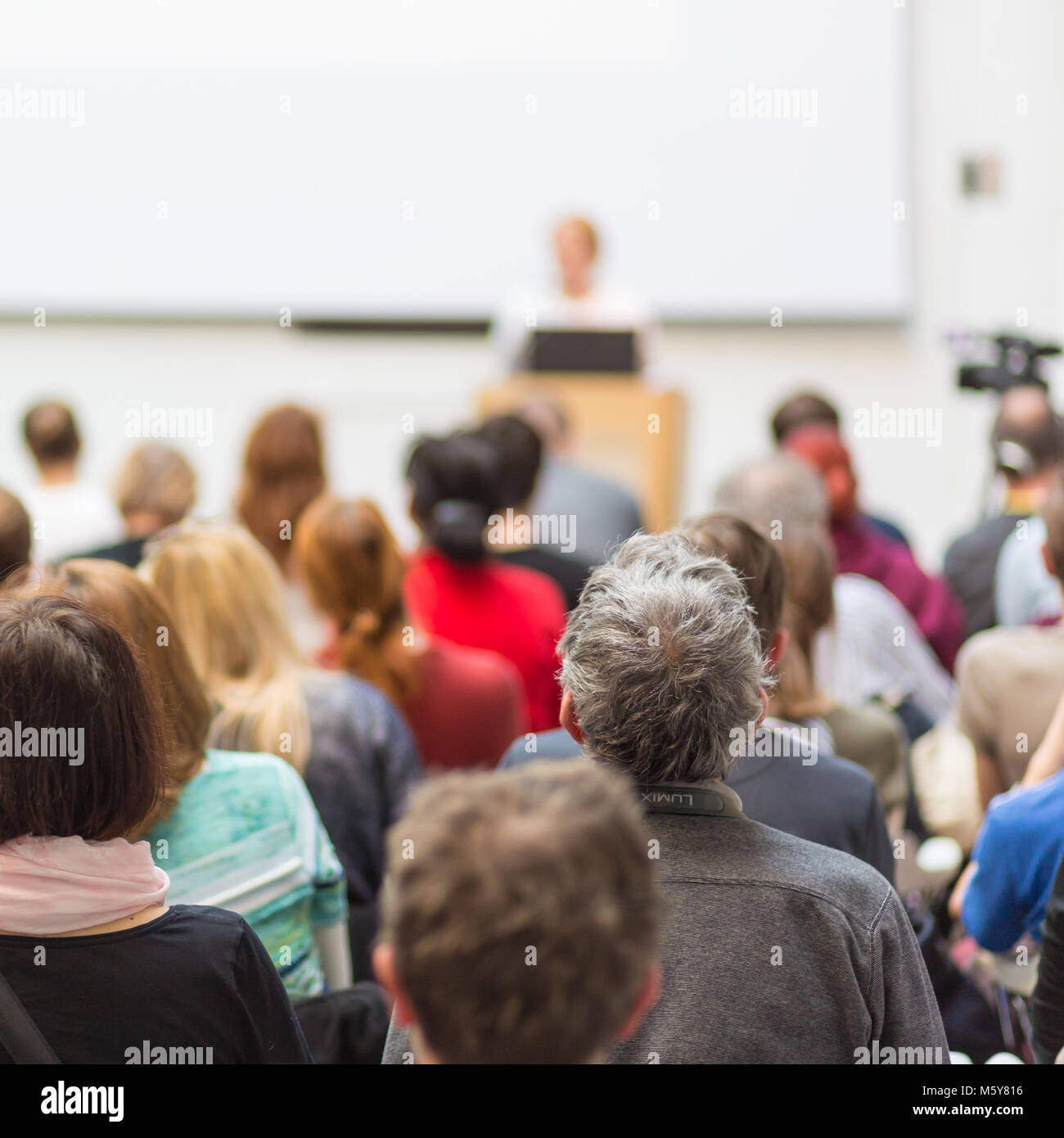 Woman giving presentation in lecture hall at university Stock Photo - Alamy