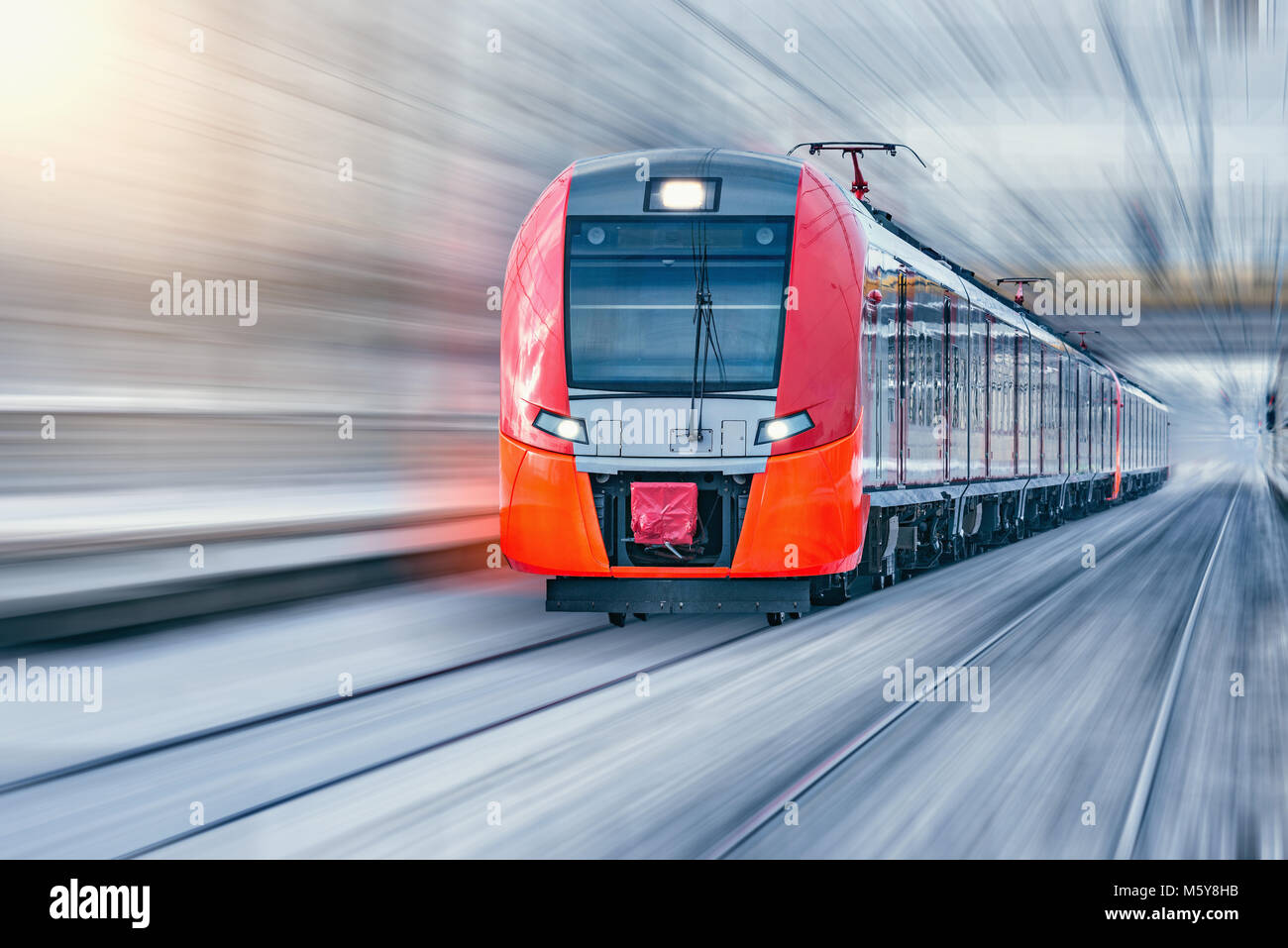 Modern high-speed train moves fast at winter evening time Stock Photo ...
