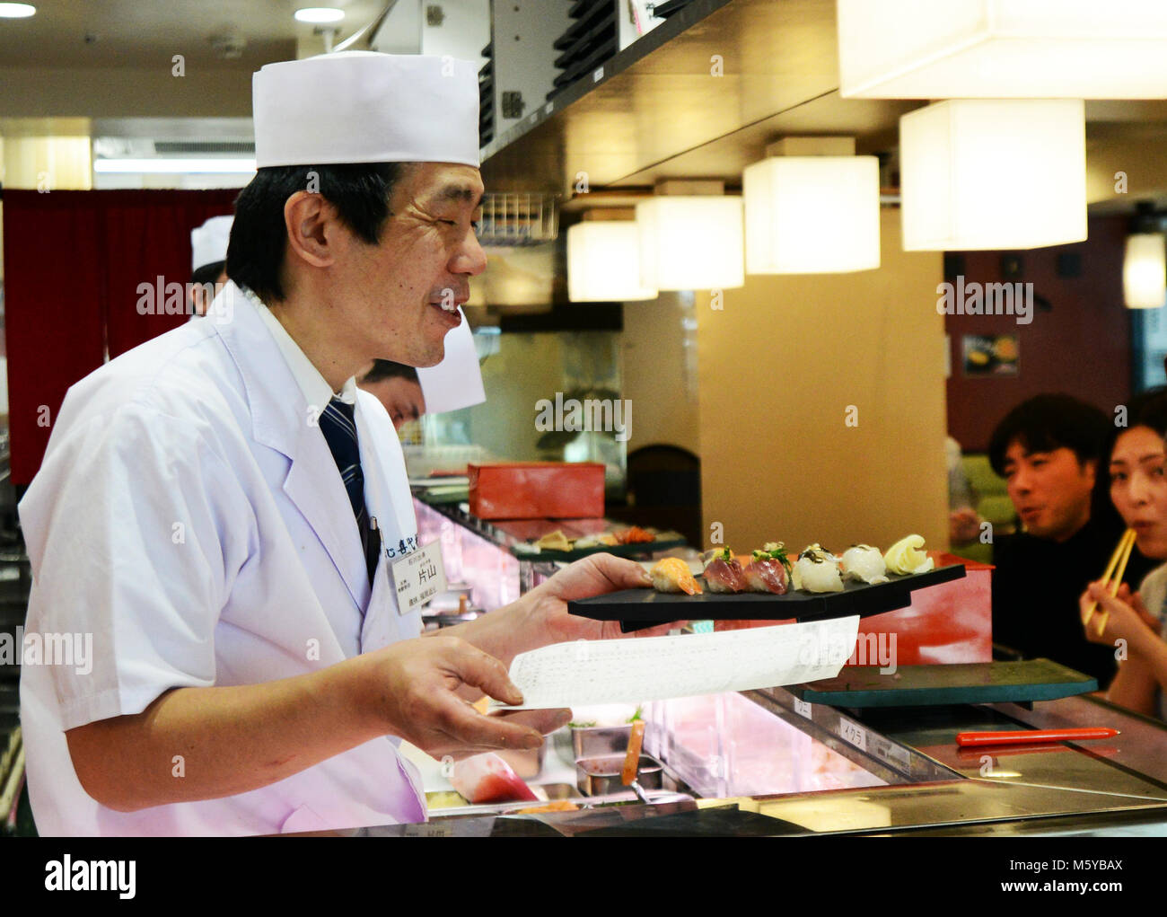 An Itamae - A Sush master-chef preparing a platter of Sushi in a Sush ...
